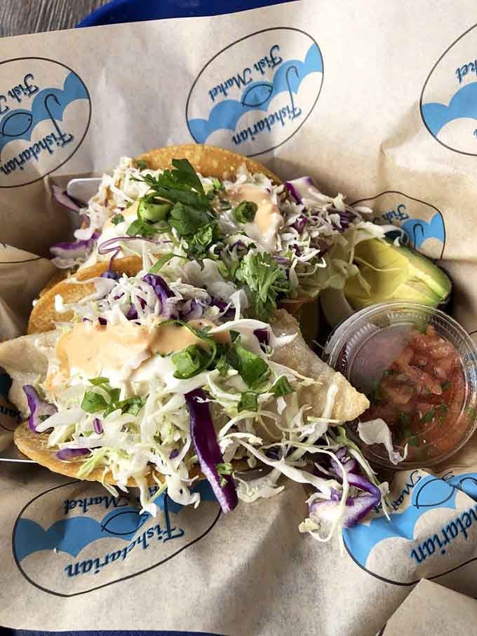 Two tacos loaded with shredded cabbage, chipotle aioli, pico de gallo, and avocado. Coastal California on a corn tortilla.