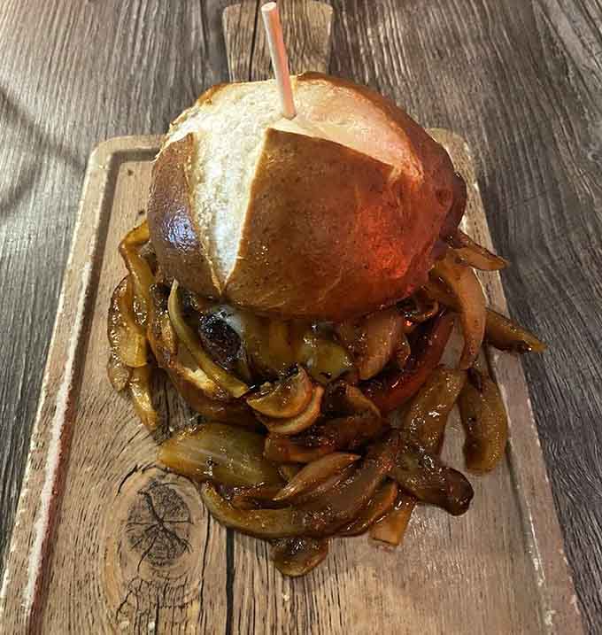 Caramelized onions and mushrooms cascading off a brioche bun like a delicious avalanche you'd happily get buried under.