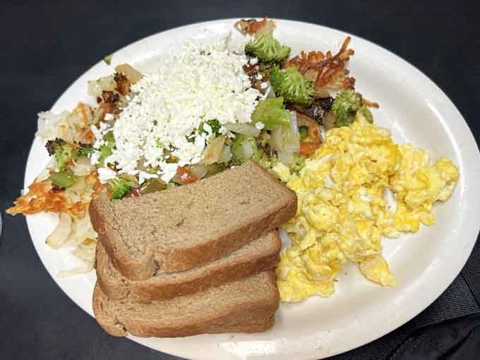 Scrambled eggs, crispy hash browns, saut&eacute;ed vegetables, and crumbled feta. Breakfast that actually gives you a reason to get out of bed.