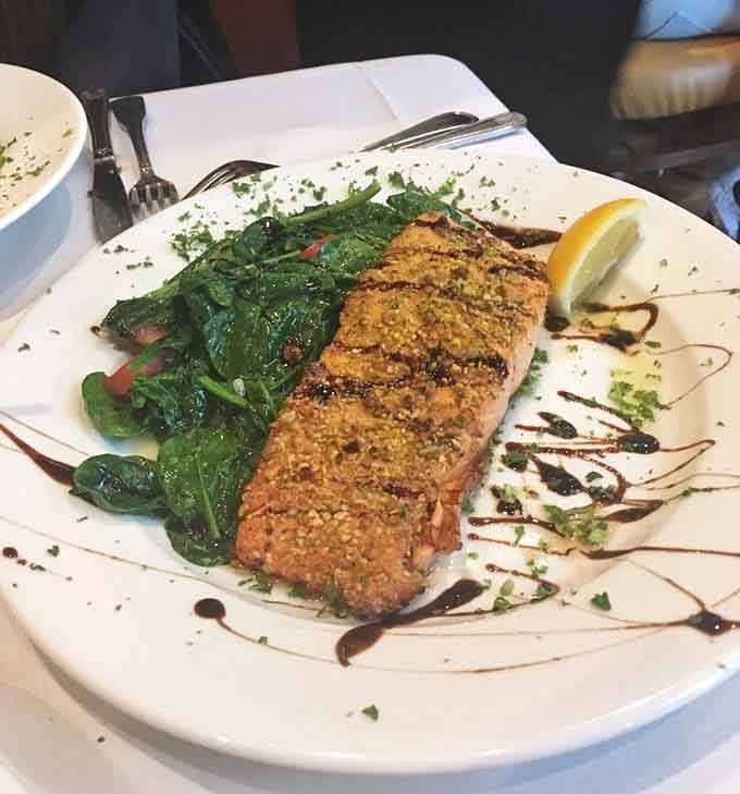 Pistachio-crusted salmon over wilted spinach with a balsamic drizzle, proof that elegant and delicious aren't mutually exclusive.