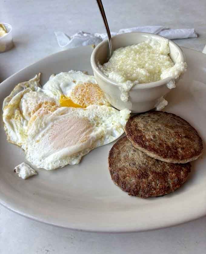 Eggs, sausage patties, and a bowl of grits so creamy it deserves its own standing ovation.