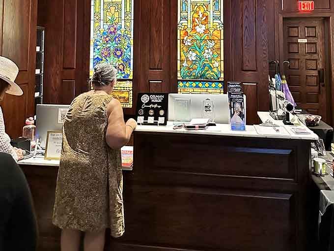 Even the welcome desk has stained glass behind it, because why would anything here be ordinary?
