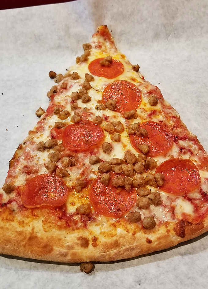 Pepperoni and sausage piled high on a foot-long canvas. This is what ambition looks like in pizza form.