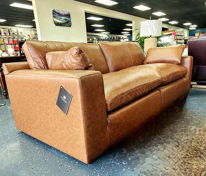 This caramel-colored leather sofa is giving serious mid-century vibes and probably costs less than your phone bill.