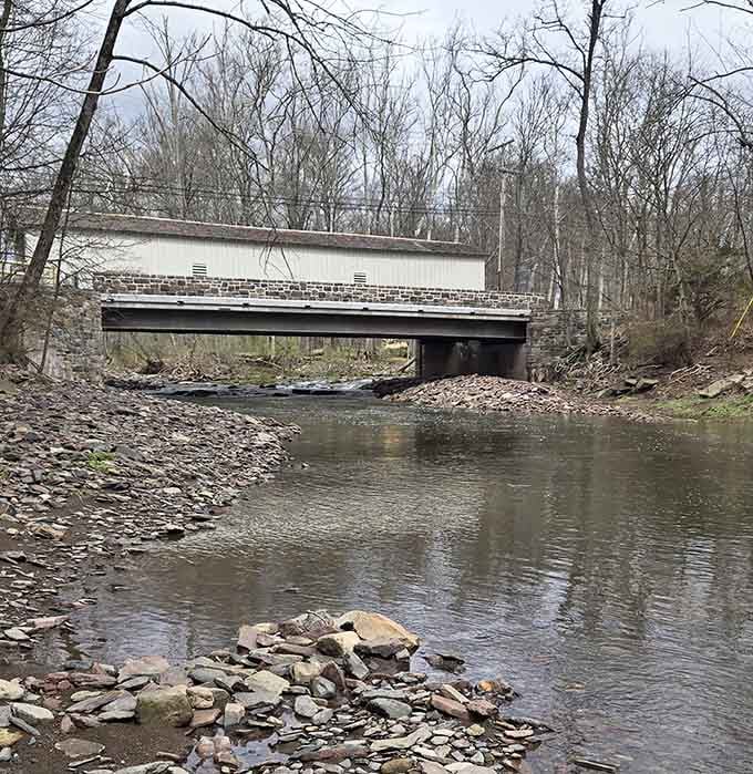 From down at the creek, you realize the stone foundation isn't just pretty, it's the reason this bridge is still standing.