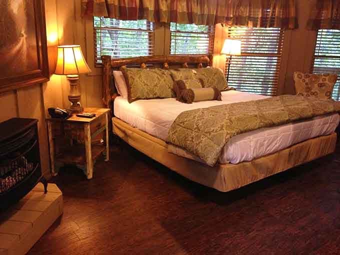 Rustic log furniture meets actual comfort in a bedroom that makes camping look like the amateur hour it is.