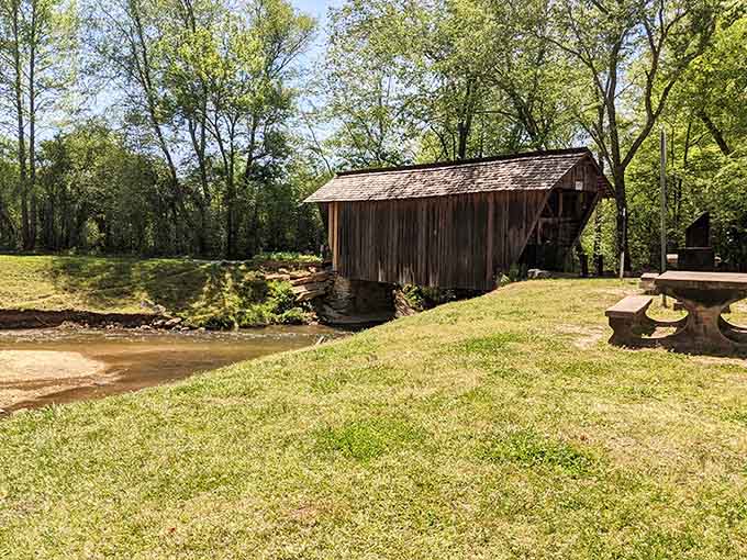 Picnic tables, a babbling creek, and a historic bridge nearby. This is what a perfect afternoon looks like.