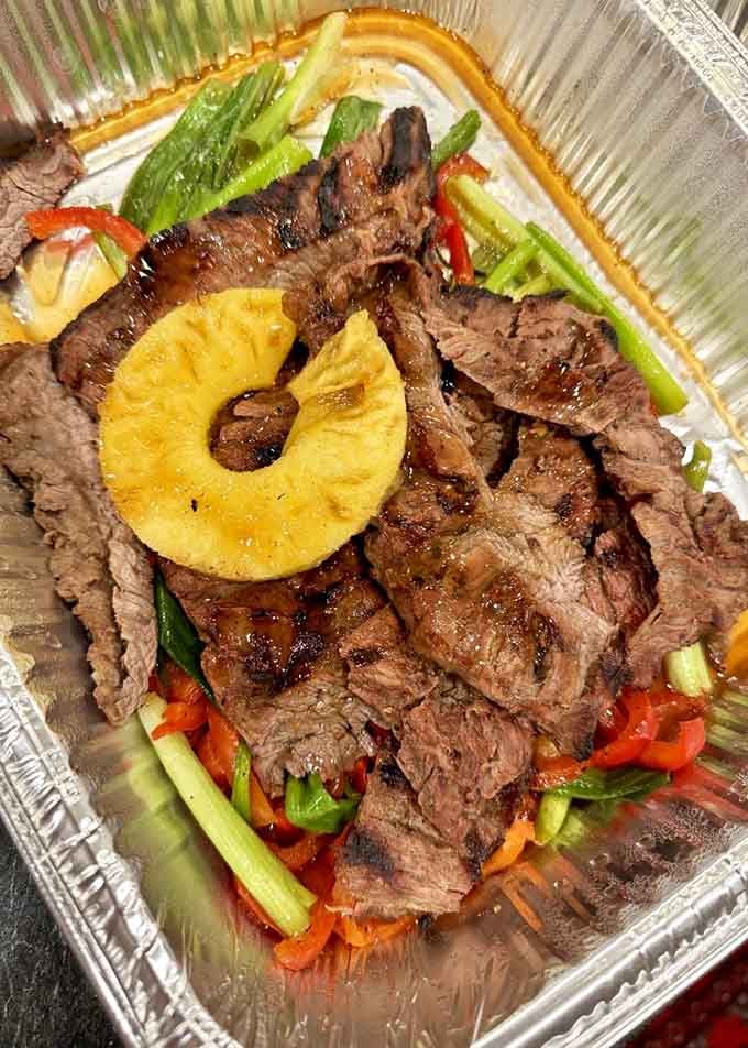 Grilled beef with a charred pineapple ring on top, because sometimes Hawaii and Texas just need to meet.