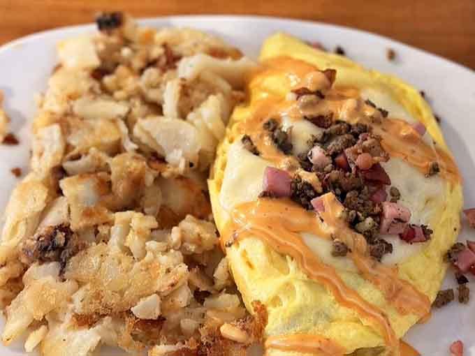 That fluffy omelet paired with golden hash browns looks like Sunday morning decided to dress up fancy.