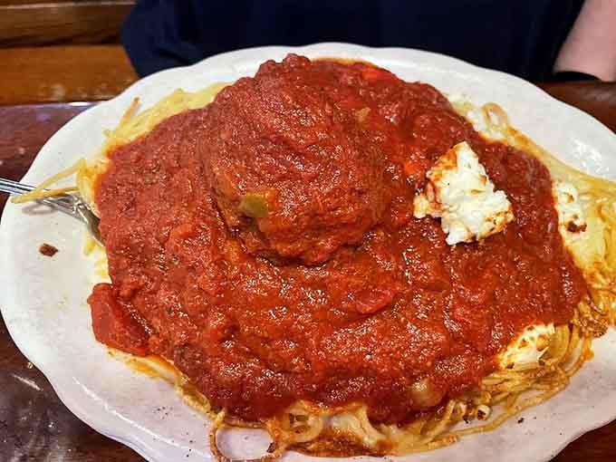 The Spaghetti A La Greek arrives loaded with toppings, a side of marinara, and zero apologies.