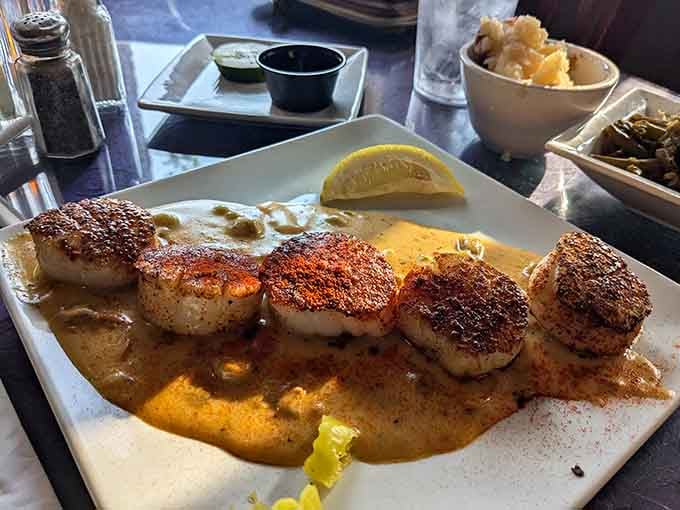 Seared scallops dusted with Cajun spice, resting in a rich sauce. Louisiana called, Kentucky answered.