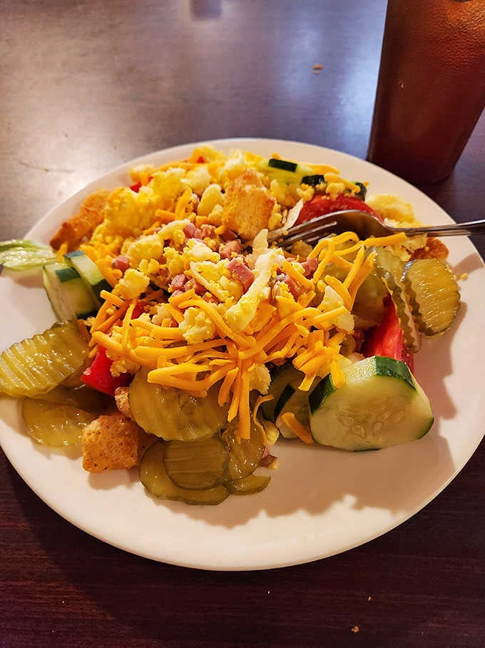 The salad bar built for serious business, piled high with cheese, cucumbers, pickles, and enough toppings to keep things interesting.