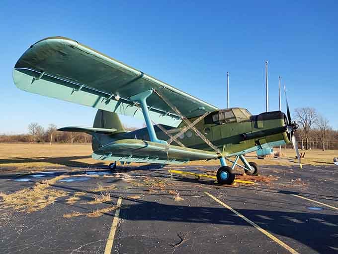 This vintage biplane parked outside has seen things, and it's not in any hurry to talk about them.