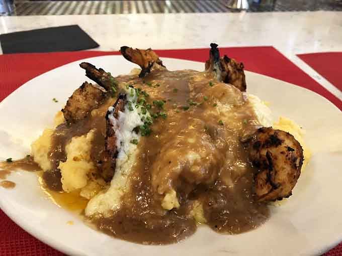 Blackened shrimp, silky grits, and a gravy pour so generous it deserves its own round of applause.