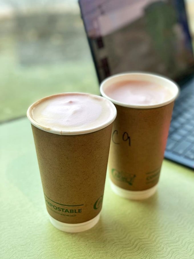 Two warm lattes sitting by the window with a laptop nearby. Productivity has never looked this cozy or smelled this good.