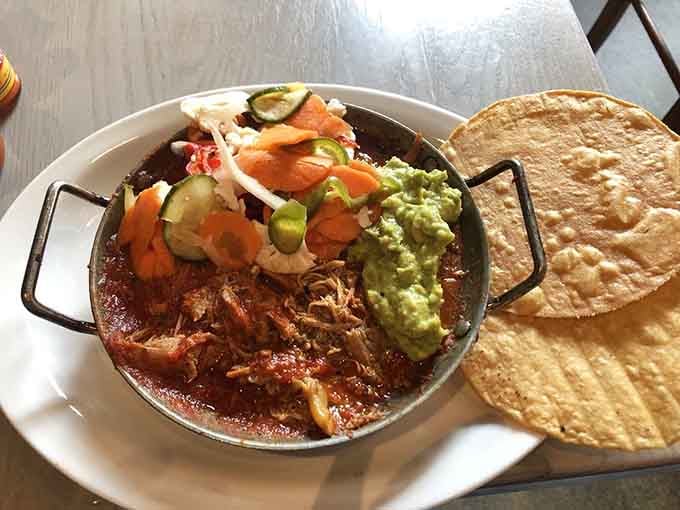 Braised duck in rich sauce, topped with pickled vegetables and guacamole, served with handmade tortillas. Dinner just got very serious.