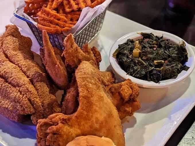 Crispy catfish, golden wings, collard greens, and sweet potato fries. This plate is not here to negotiate.