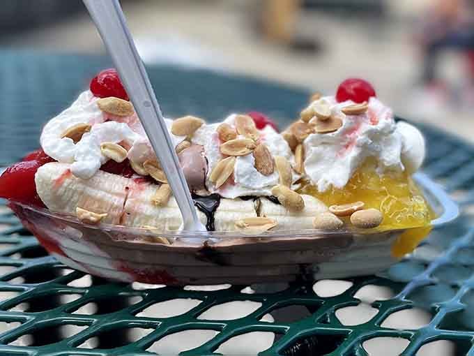 This banana split topped with sliced almonds and cherries looks like summer vacation decided to take permanent residence in Little Orleans.