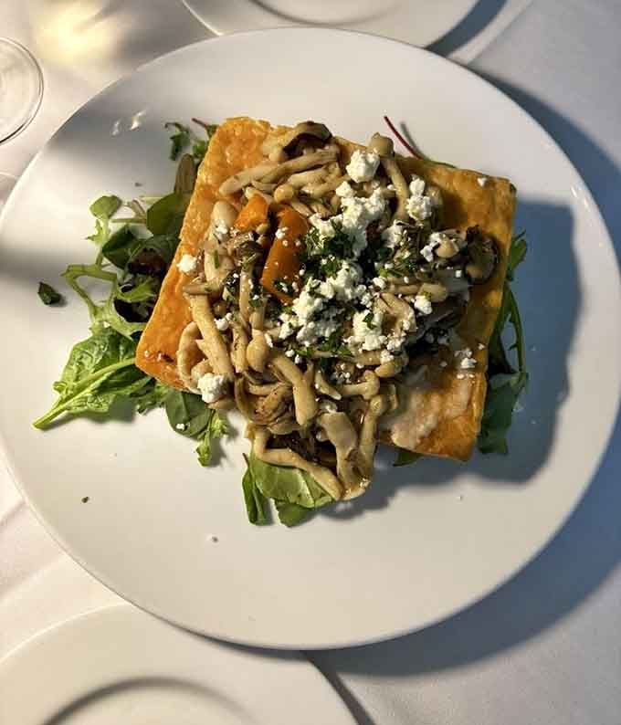 Crispy pastry, earthy mushrooms, and crumbled cheese stacked together like the most sophisticated thing your fork has ever met.