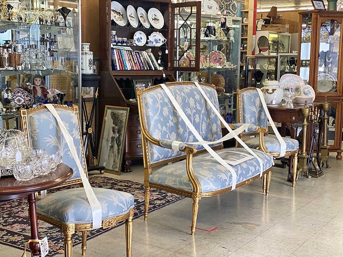 A gilded French-style seating set in powder blue, the kind of furniture that makes you want to sit up straighter just looking at it.