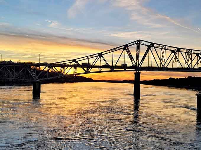 When the Tennessee River catches a sunset like this, even the bridge forgets it's supposed to be retired.