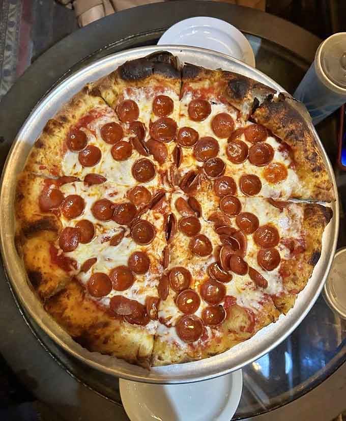 Pepperoni so perfectly placed it looks intentional. Crispy edges, golden cheese, and enough confidence to silence any room immediately.