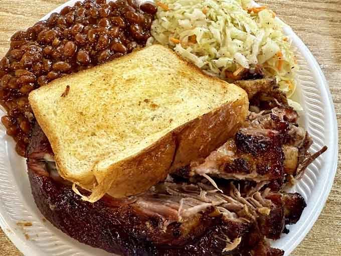 Brisket, pulled pork, and garlic toast sharing a plate, a combination that deserves its own holiday.