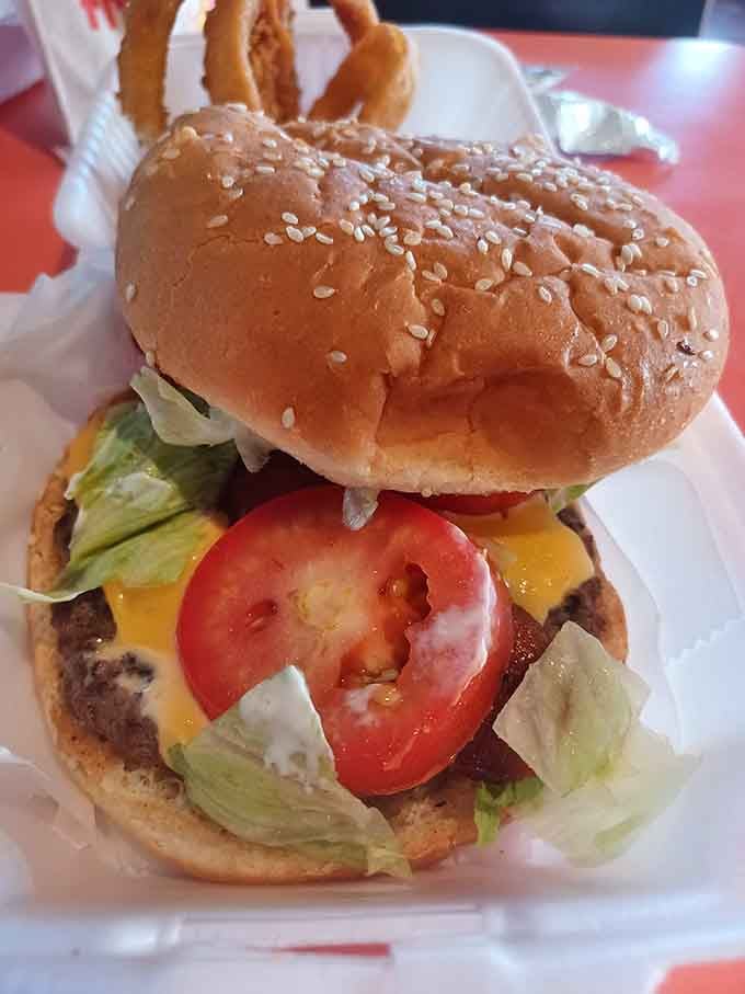 A proper cheeseburger with tomato, lettuce, and melted cheddar. No apologies, no pretense, just delicious.