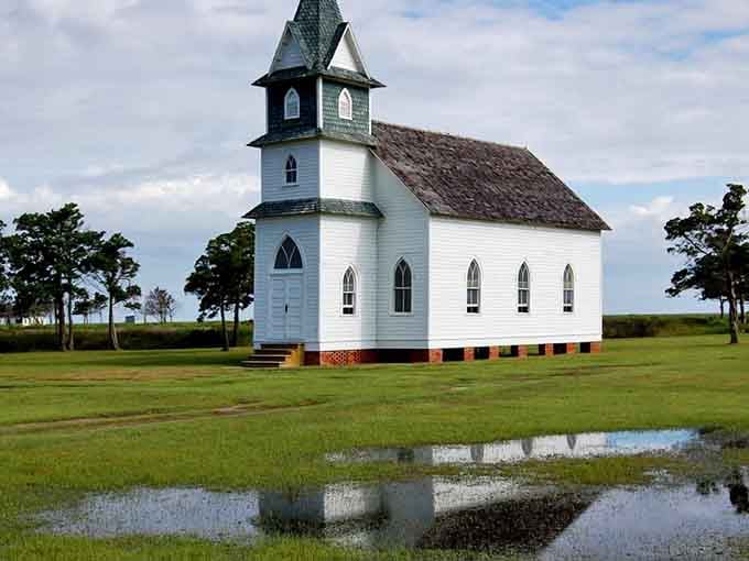 The church's Gothic arches mirror perfectly in the rainwater below, doubling the beauty without charging extra admission.