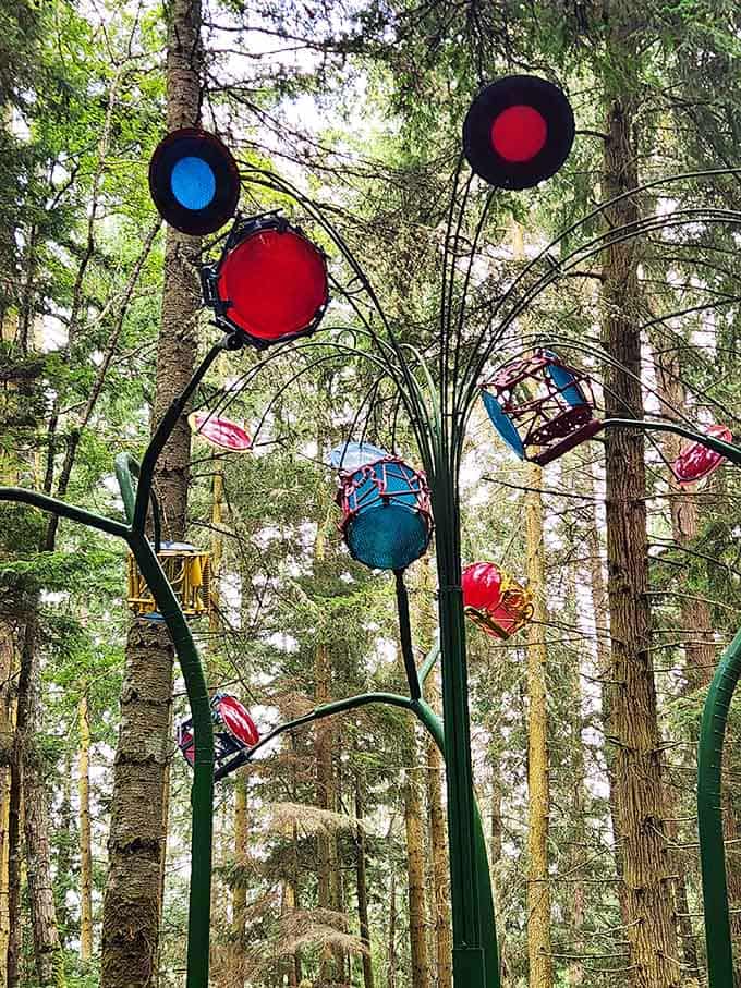 Colorful orbs and bold red discs rise high into the canopy, like a jukebox decided to become a tree.