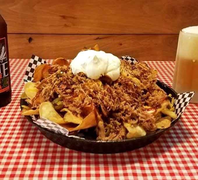 A mountain of pulled pork nachos so generously loaded, it deserves its own zip code and a round of applause.