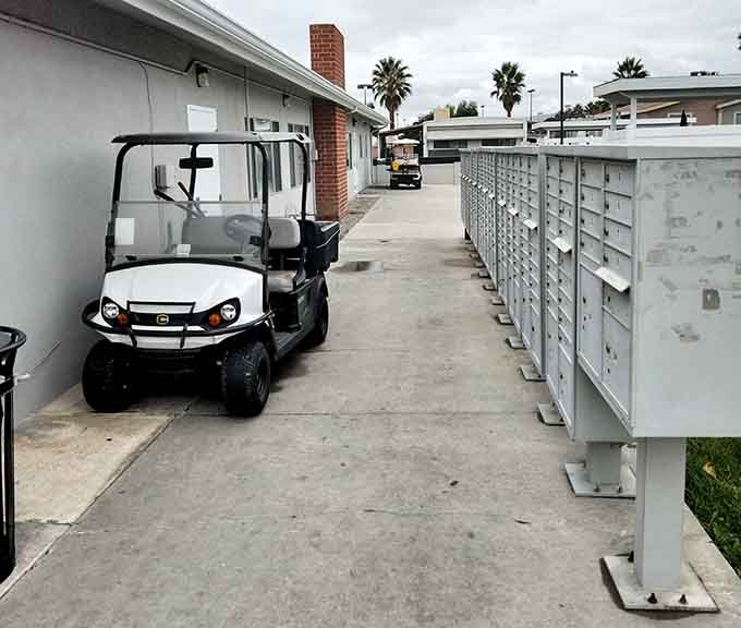 A golf cart by the mailboxes, because why walk when you can ride in style.