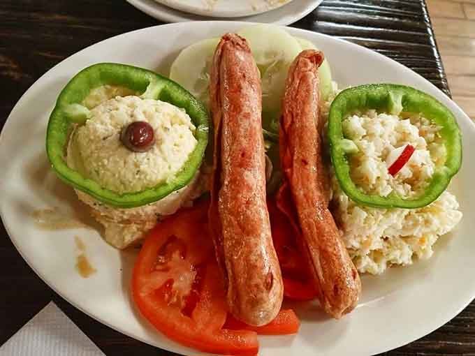 Two deep-fried hot dogs on a platter with potato salad and coleslaw. Simple, beautiful, and completely serious.