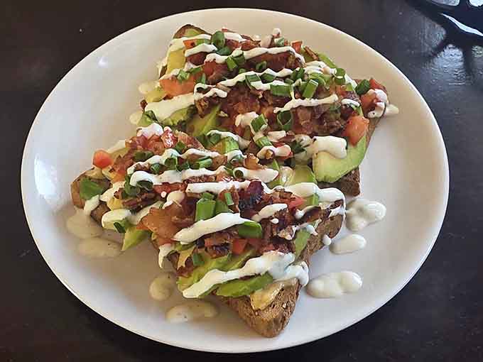 Loaded avocado toast so generously topped, you'll need a moment just to take it all in before diving in.