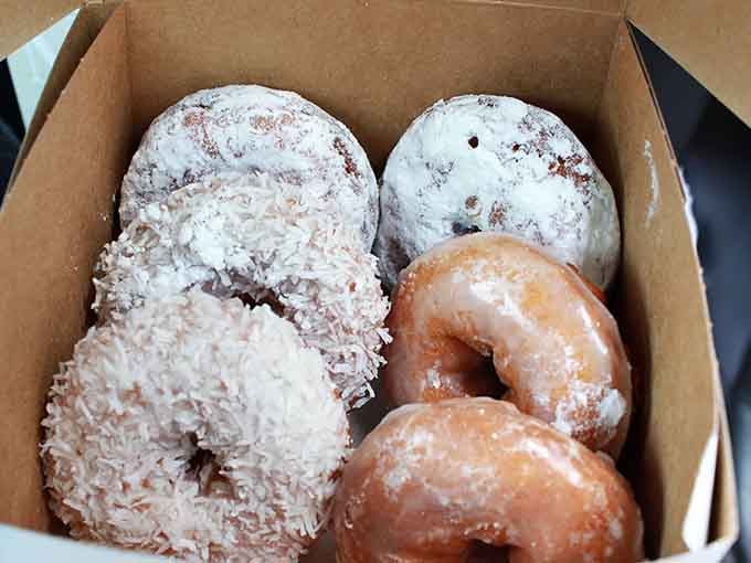 A box of coconut, powdered, and glazed donuts so good, you'll guard it on the drive home like it's treasure.