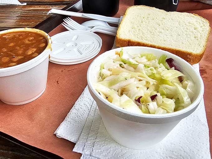 Coleslaw, beans, and white bread, the holy trinity of sides that make every bite of smoked meat even better.
