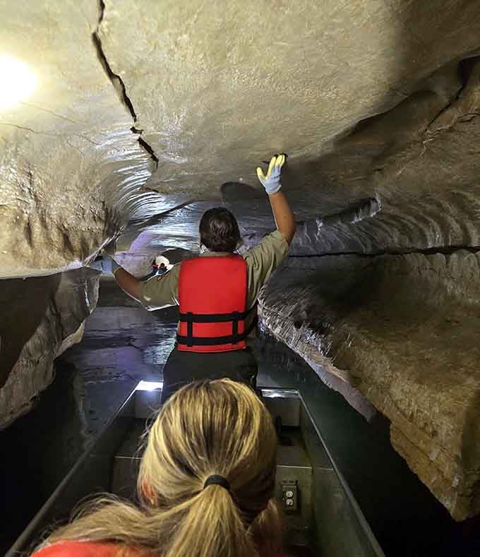 A guide pushes through the cave ceiling inches above, the kind of adventure your living room cannot offer.
