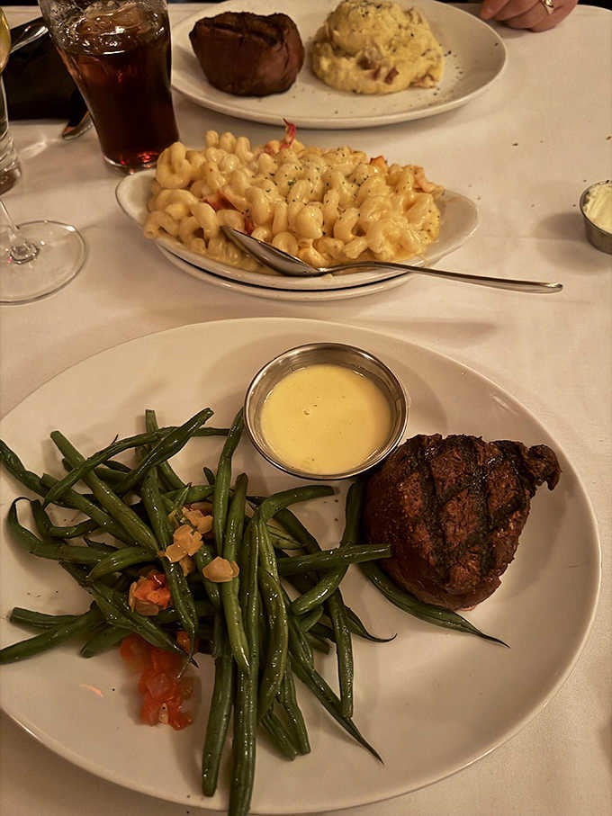 Filet mignon with b&eacute;arnaise sauce alongside crisp green beans, proof that elegance and comfort belong on the same plate.