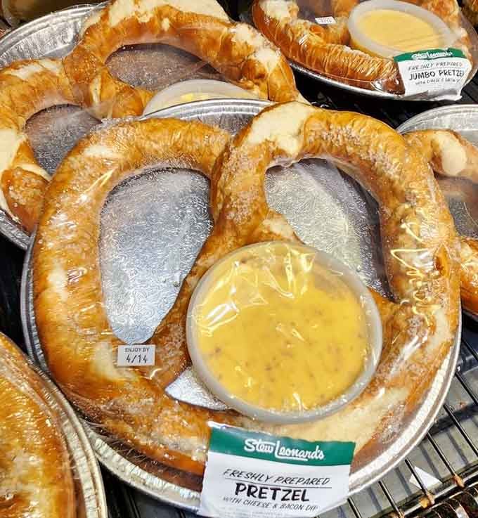 A freshly prepared jumbo pretzel with cheese and bacon dip. This is what snack goals actually look like in real life.