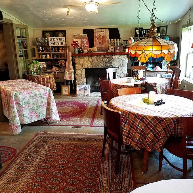 Cozy tables with plaid cloths and a stone fireplace create the farmhouse dining room of your dreams.