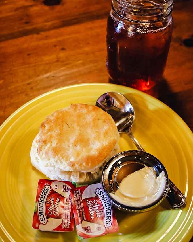 A warm biscuit, a pat of butter, apple butter packets, and iced tea in a mason jar. Virginia knows what it's doing.