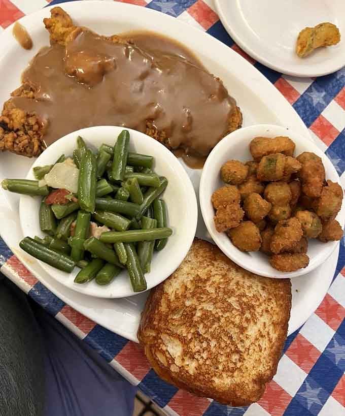 When the chicken-fried steak arrives with fried okra and green beans alongside, your afternoon plans quietly cancel themselves.