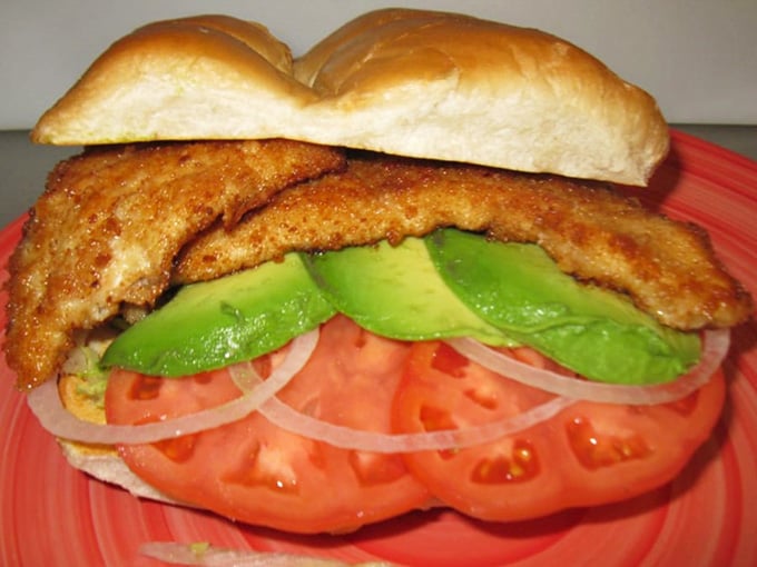 That golden-brown breaded cutlet nestled in soft bread with creamy avocado is pure torta perfection.