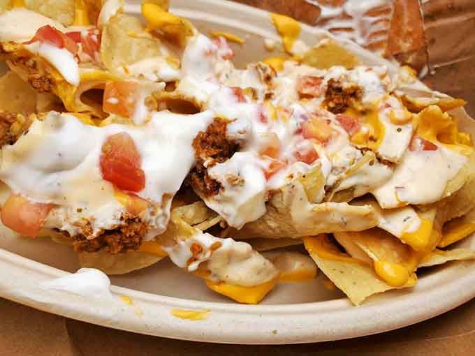Grande Nachos loaded with seasoned beef, tomatoes, cheese, and sour cream. The ocean air makes everything taste better.