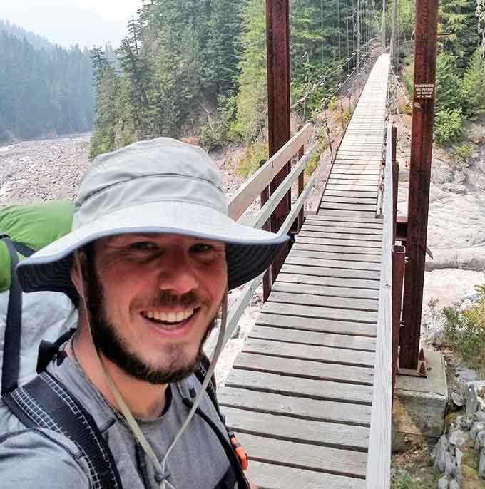 The smile says it all: crossing a 200-foot suspension bridge is absolutely worth the hike to get here.