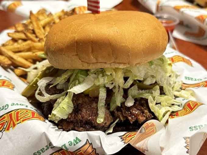 Shredded lettuce cascading like a waterfall over that beautiful smash patty. This burger isn't playing around.