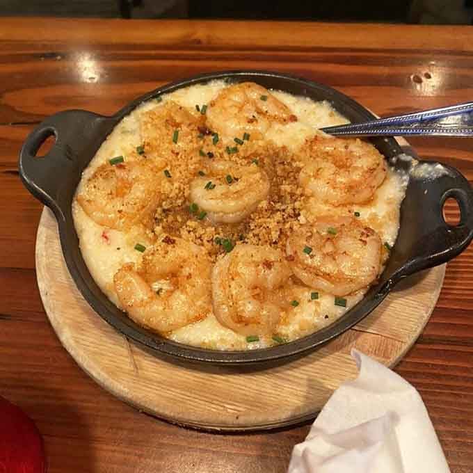 When they say generous portions of shrimp, they mean it—count those beauties nestled in creamy, dreamy grits.