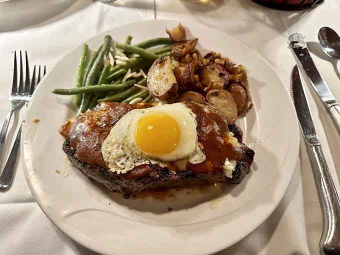 A steak topped with a fried egg and rich sauce. Breakfast and dinner finally stopped fighting and became friends.