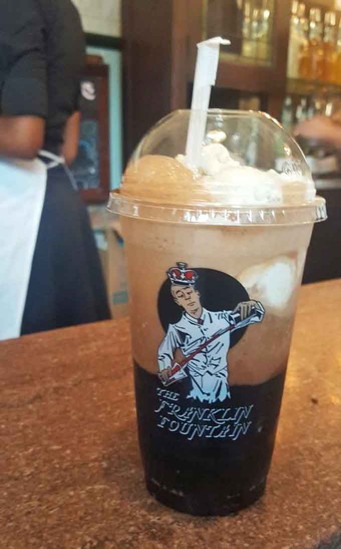 A root beer float wearing the Franklin Fountain logo like a badge of honor, rich, cold, and completely serious about itself.