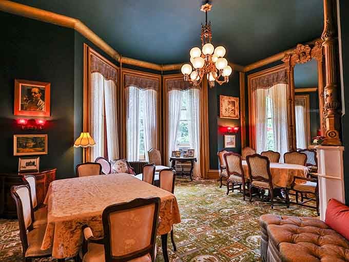 Deep teal walls, antique chairs, and a chandelier that glows like a small golden sun. Dinner here feels like an event.